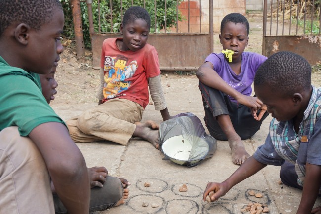 Children Play Traditional Game at Food Center in Zimbabwe